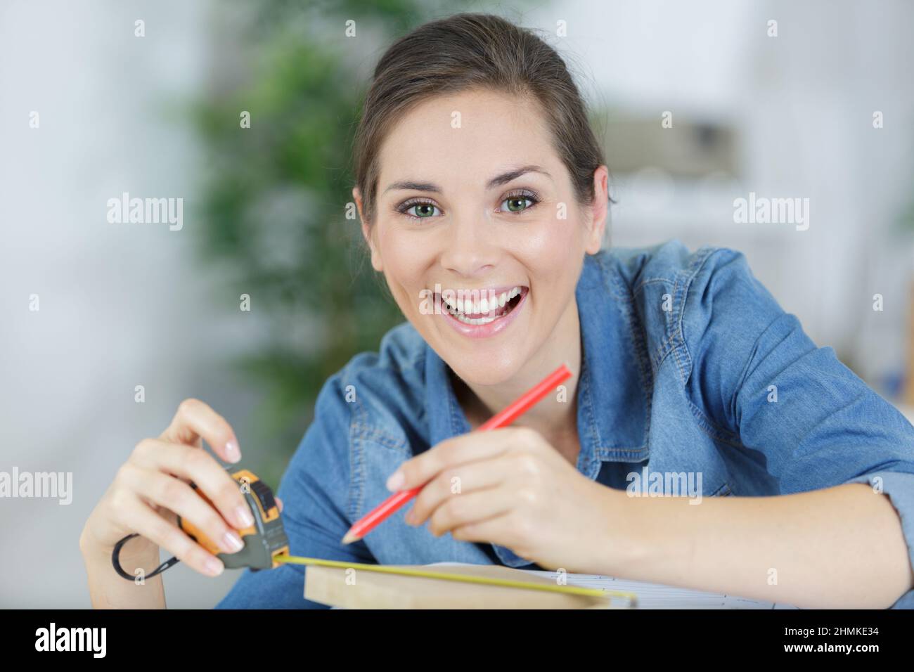 happy woman measuring window frame Stock Photo - Alamy