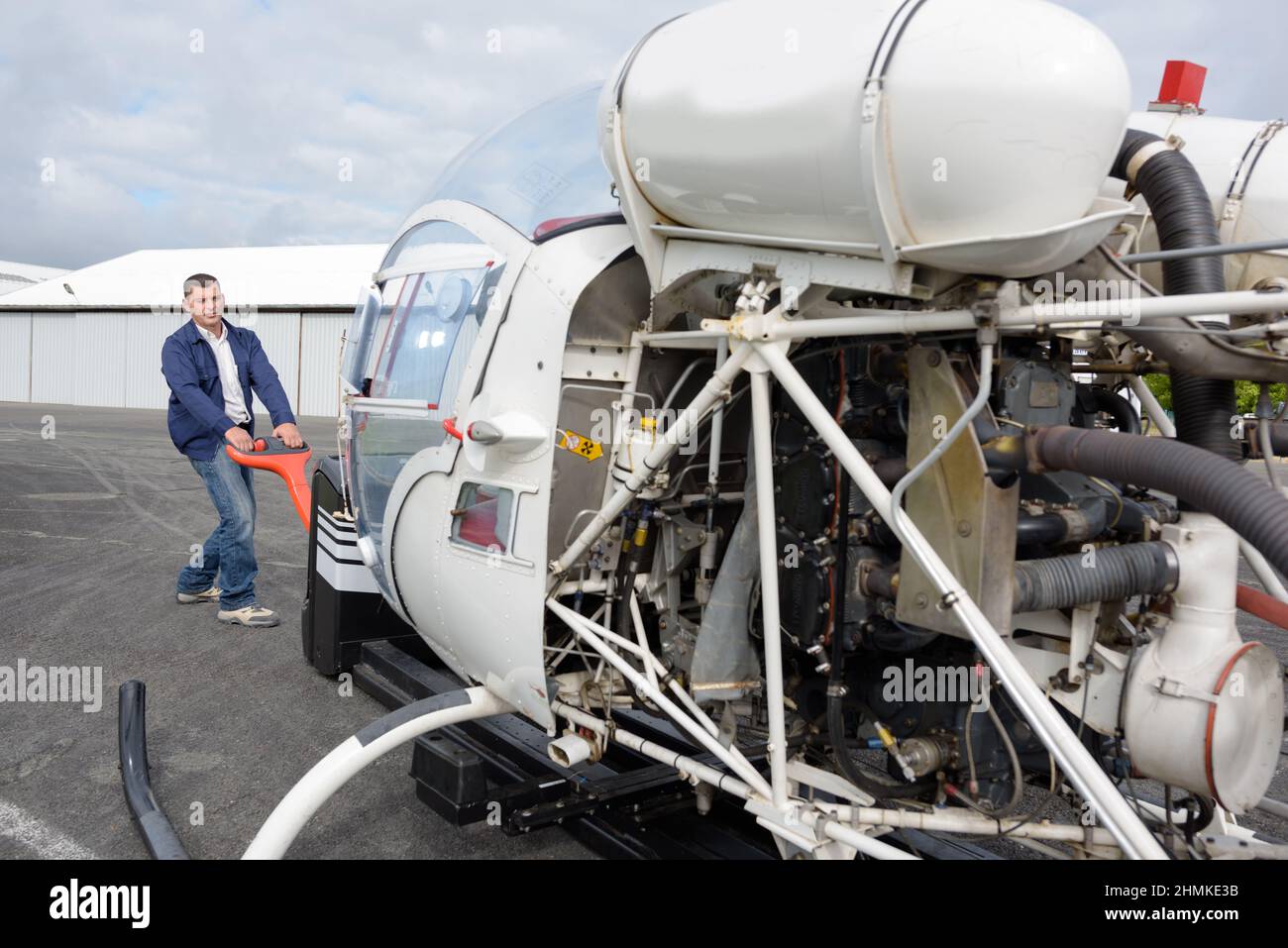 worker towing a disassembling helicopter Stock Photo - Alamy