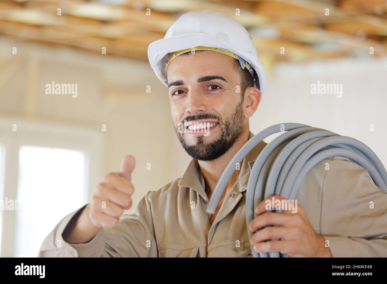 a cheerful professional engineer showing thumbs up Stock Photo - Alamy
