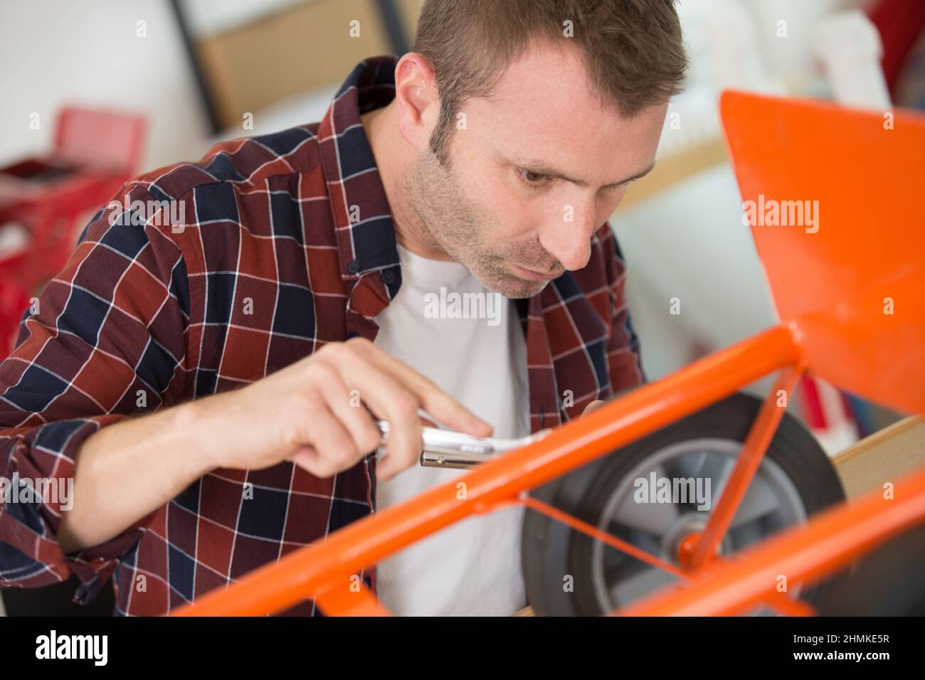 man fixing the trolley wheel Stock Photo - Alamy