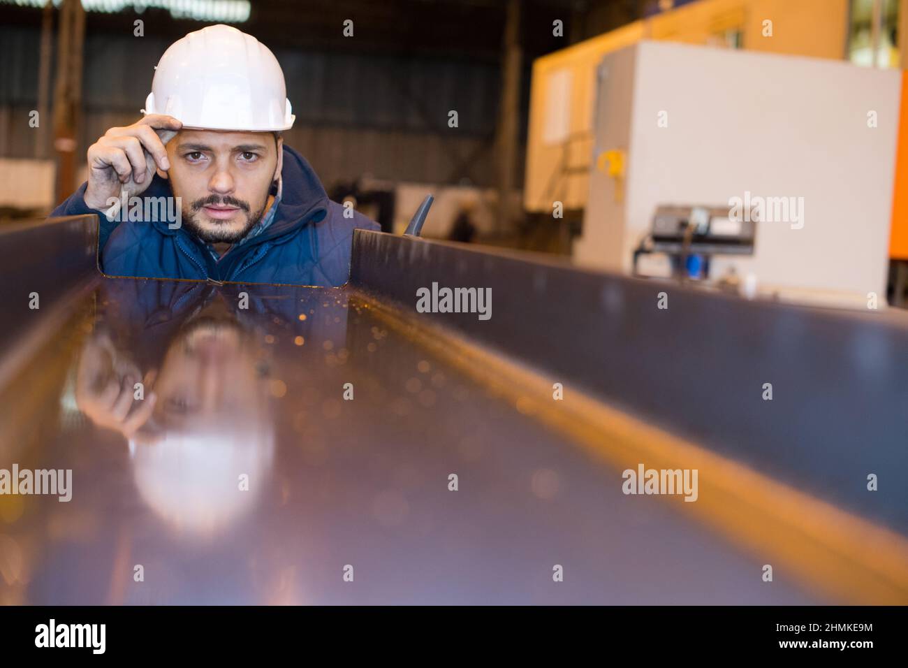 builder in hard hat looking at an industrial interior Stock Photo - Alamy