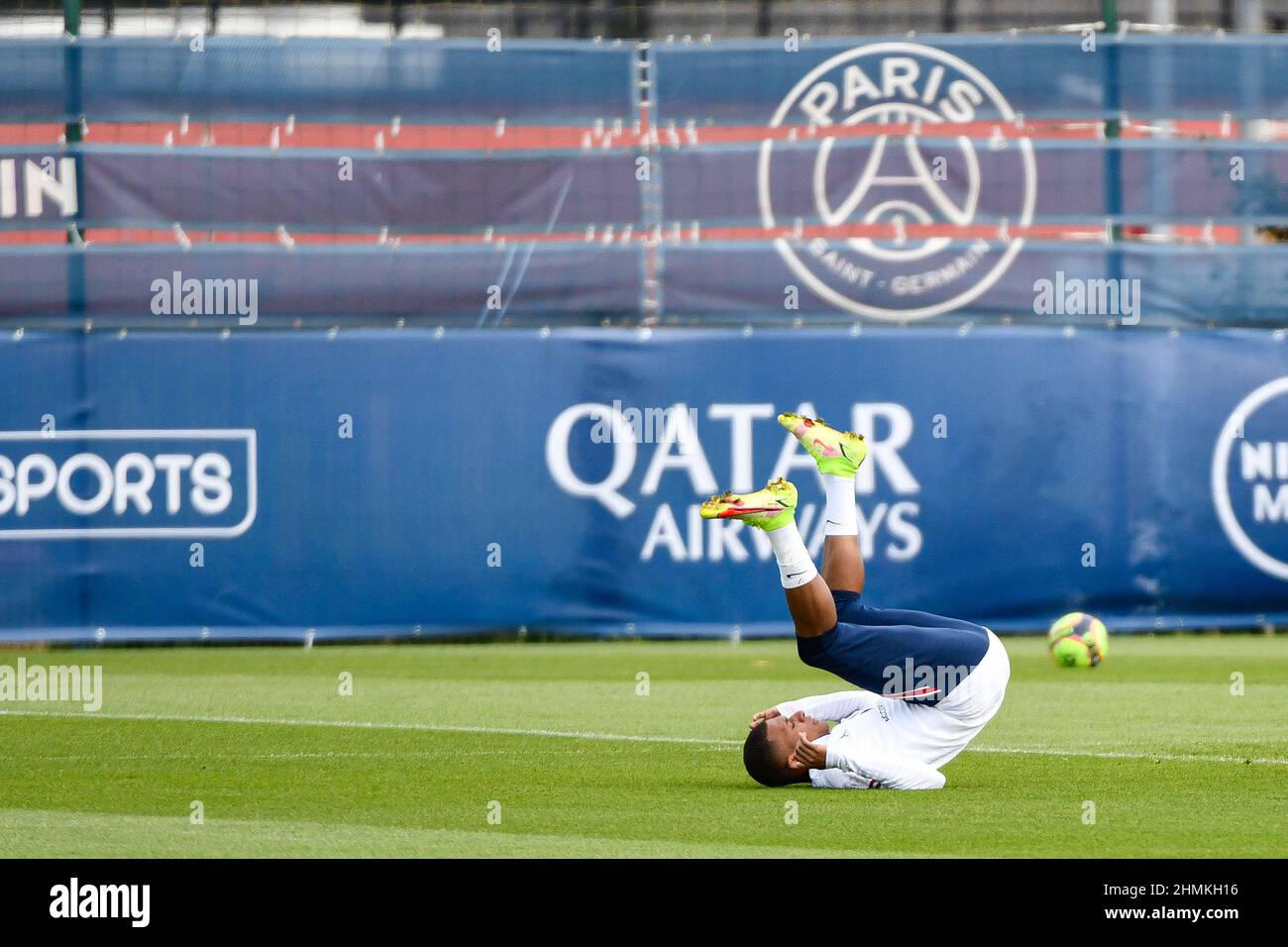 Kylian Mbappe of PSG falls during a training session at the Camp des ...