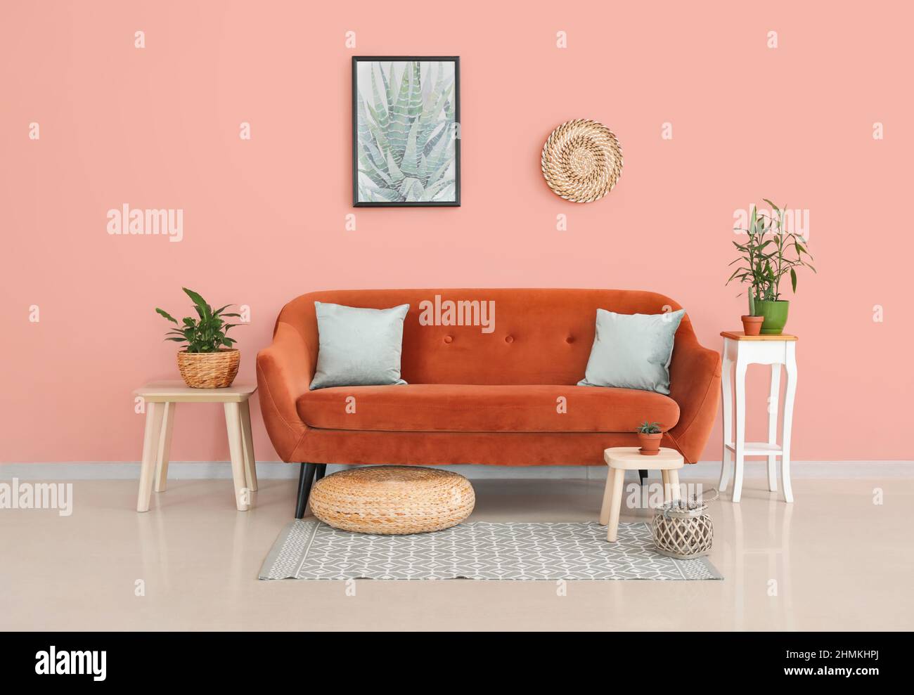 Stylish orange sofa with houseplants in modern interior of living room ...
