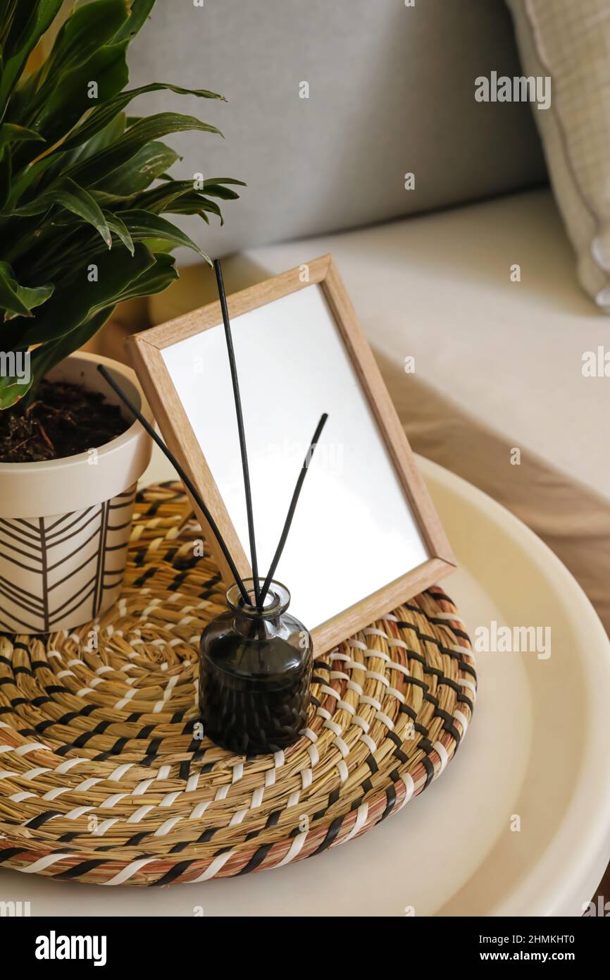 Aroma reed diffuser with photo frame on table in bedroom Stock Photo ...