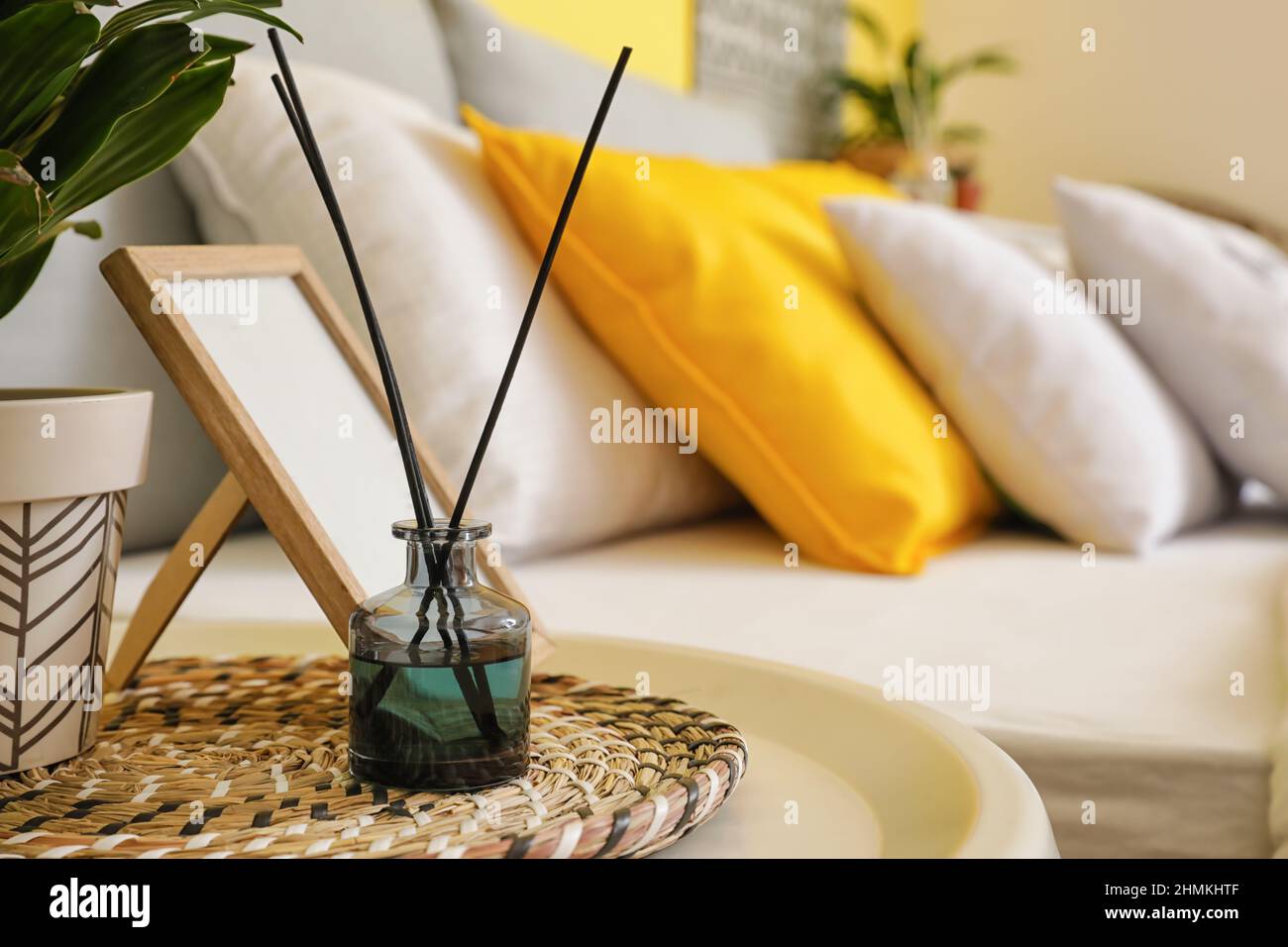 Aroma reed diffuser with photo frame on table in bedroom Stock Photo ...