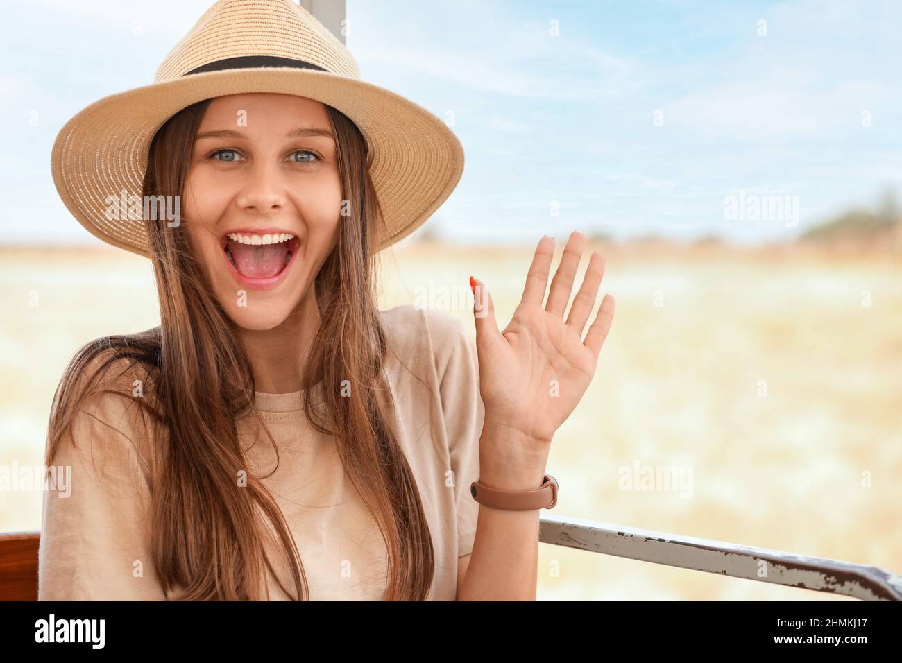 Beautiful happy female tourist on safari Stock Photo - Alamy
