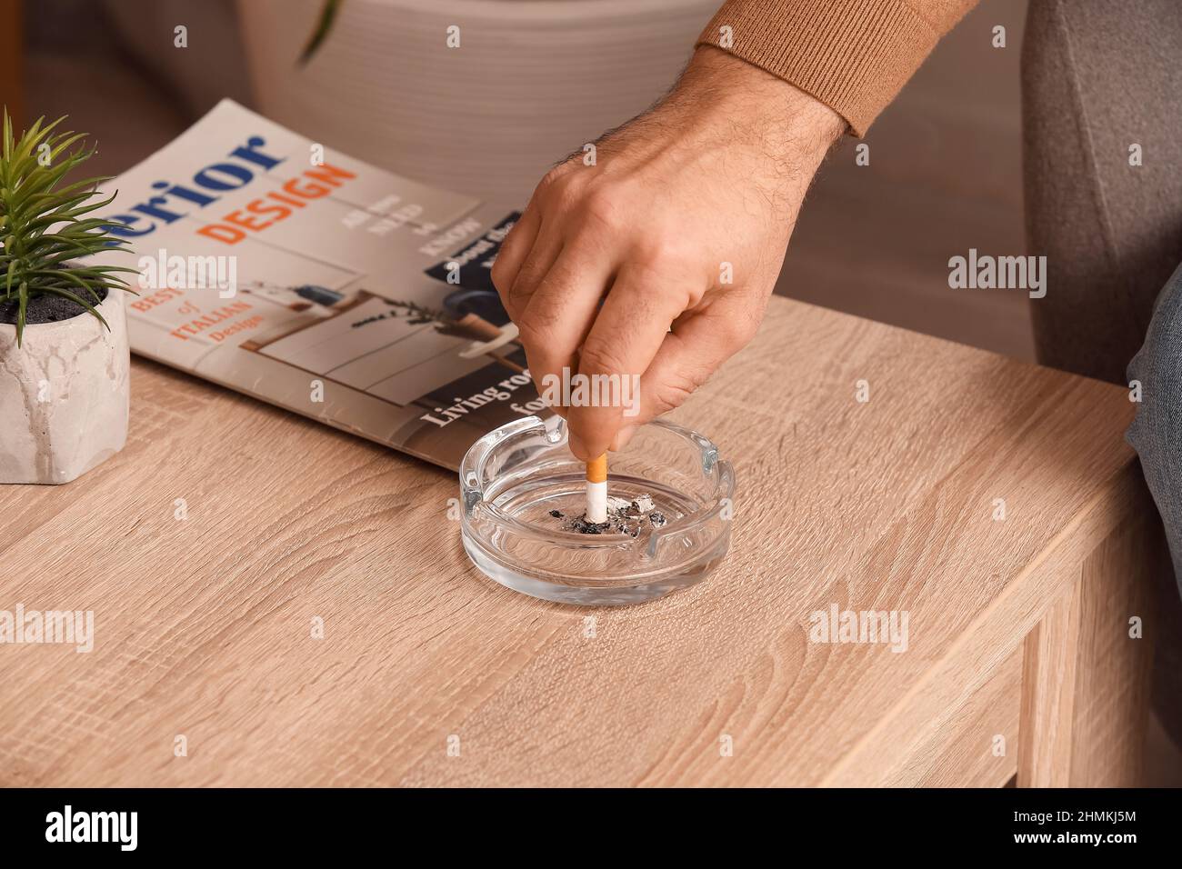 Smoking man using ash tray at home, closeup Stock Photo - Alamy