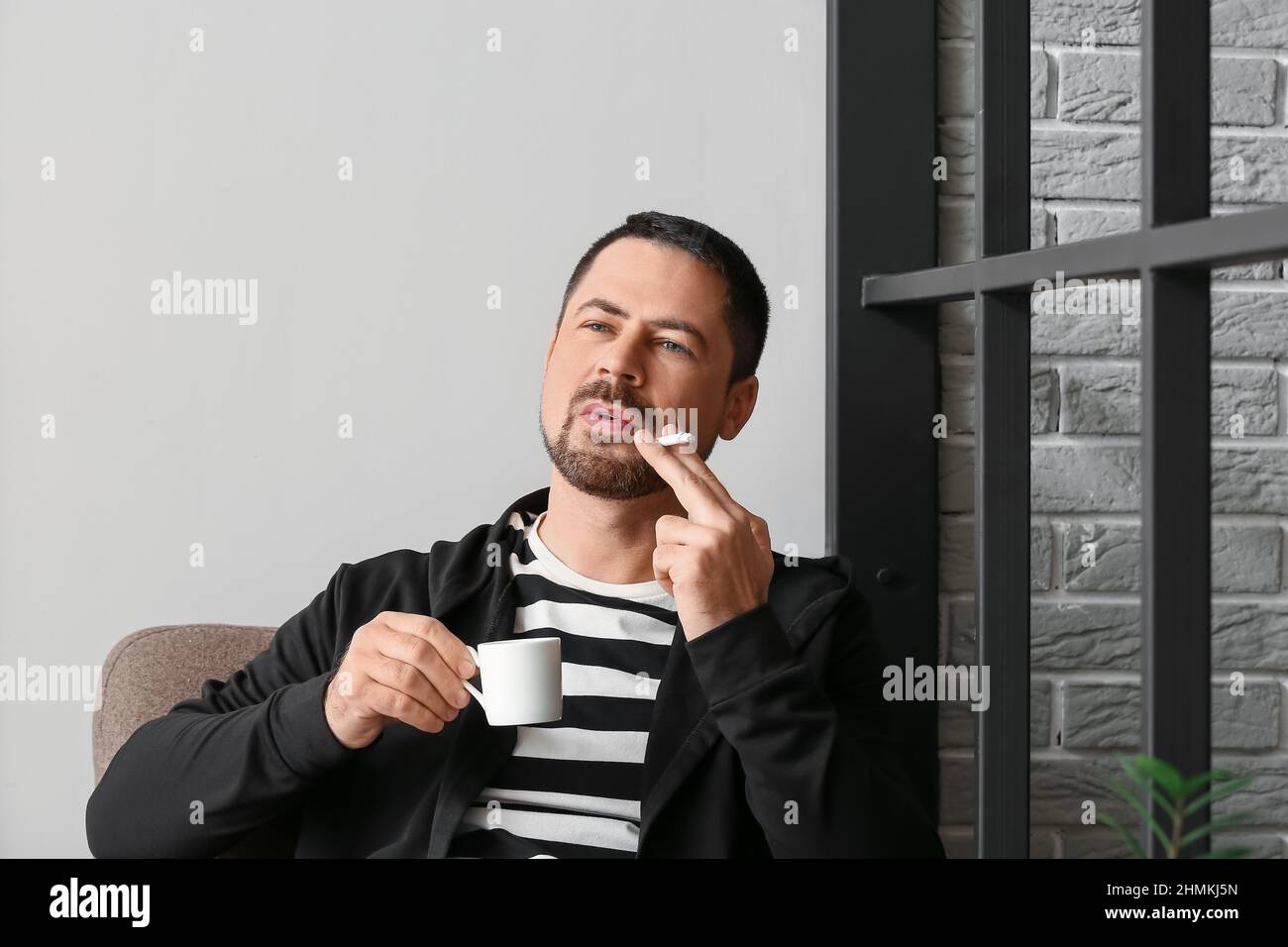 Man smoking cigarette drinking coffee hi-res stock photography and ...