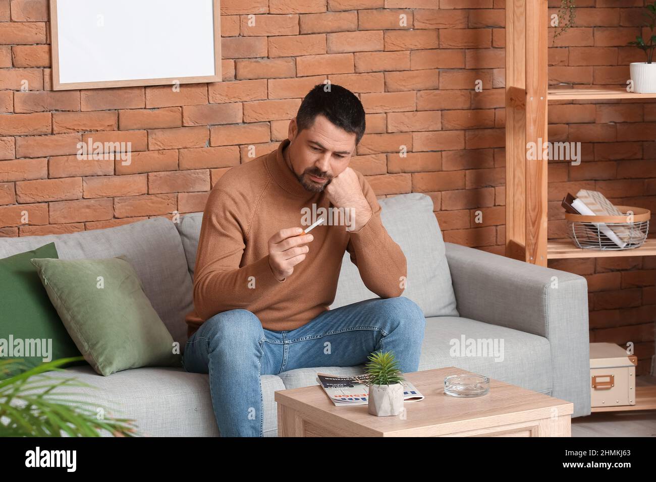 Thoughtful man with cigarette at home. Concept of refusing from bad ... Thoughtful man with cigarette at home. Concept of refusing from bad ...