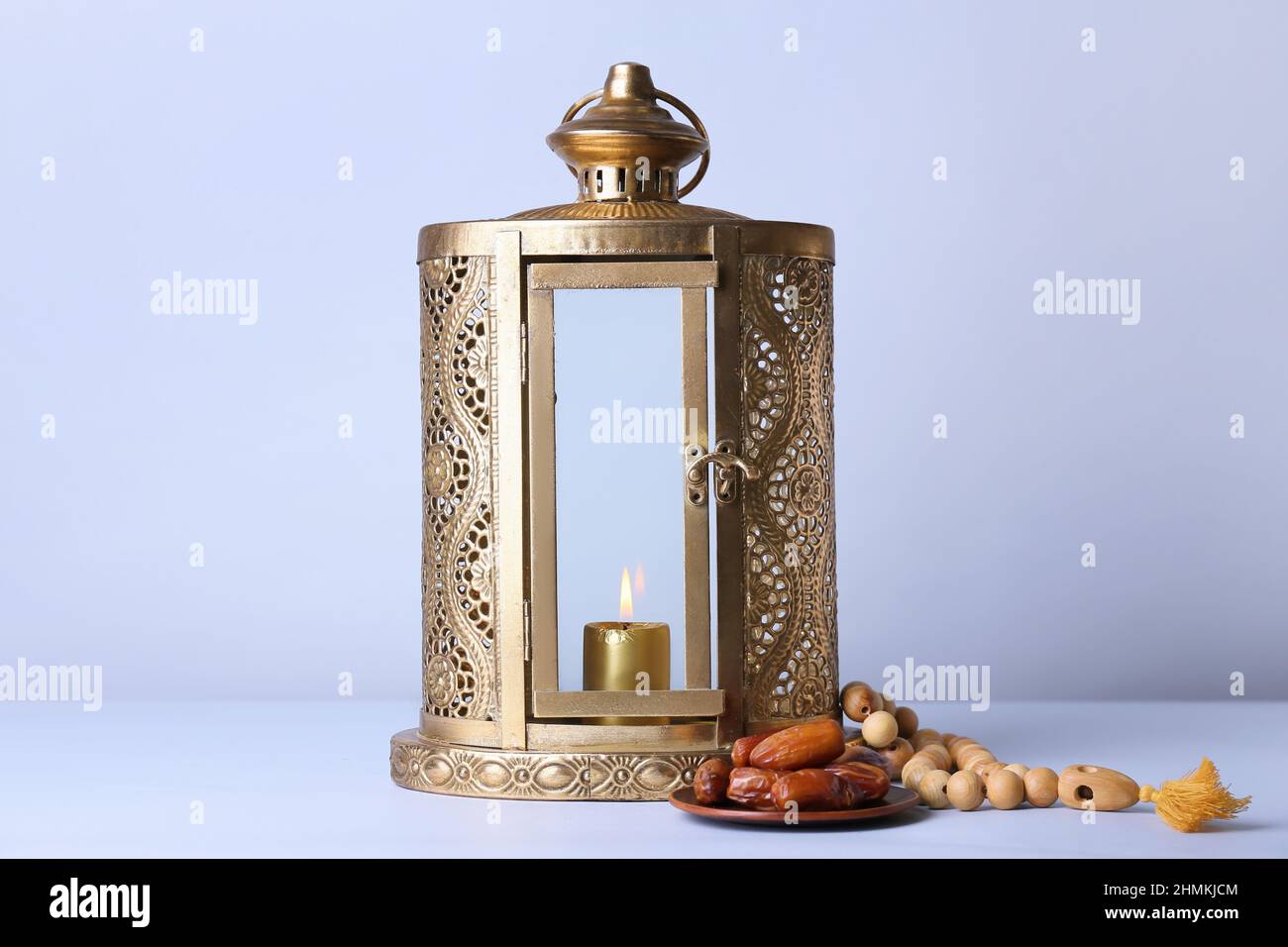 Muslim lantern, dates and tasbih on light background Stock Photo - Alamy