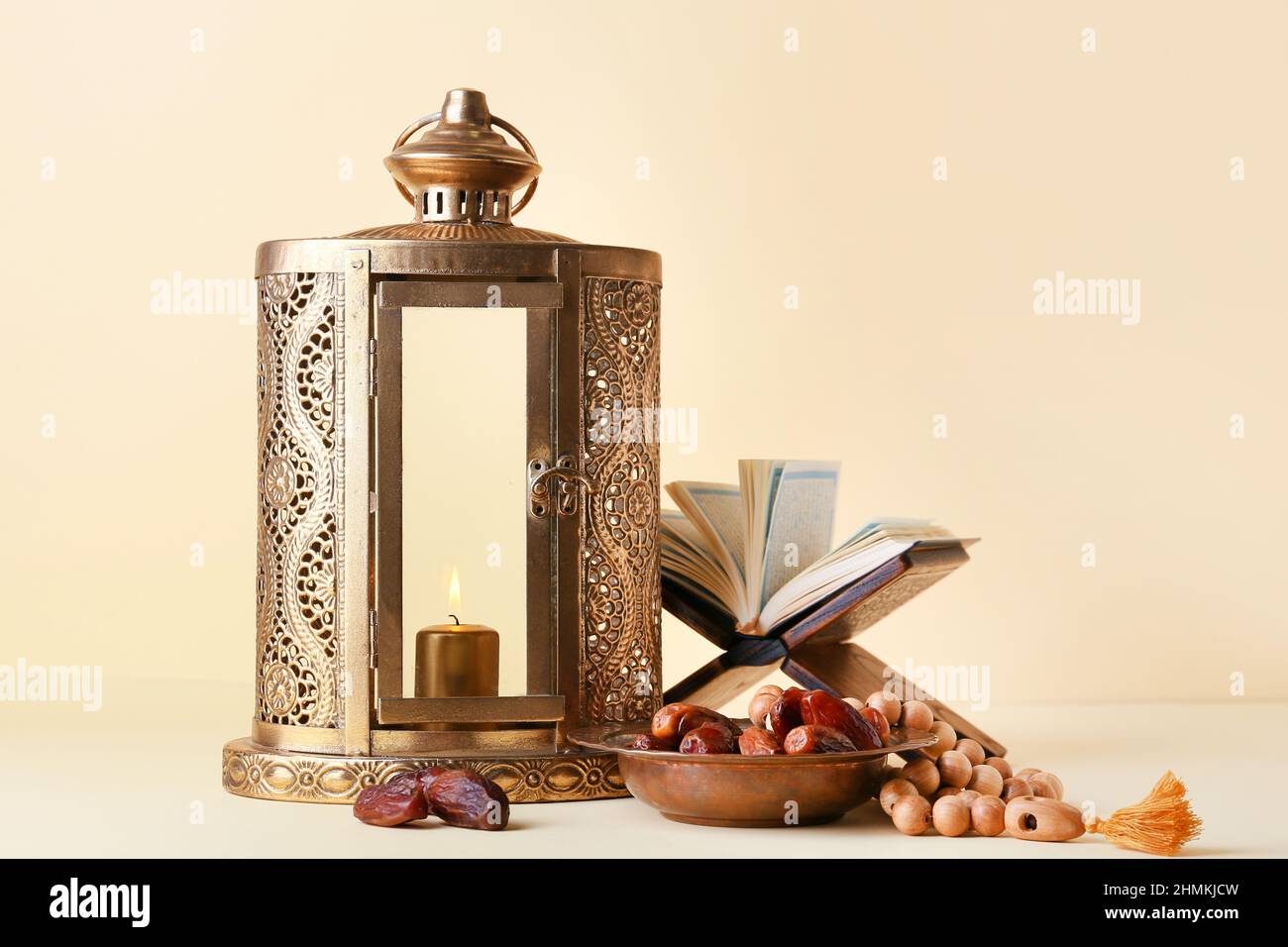 Muslim lantern, dates, Koran and tasbih on color background Stock Photo ...