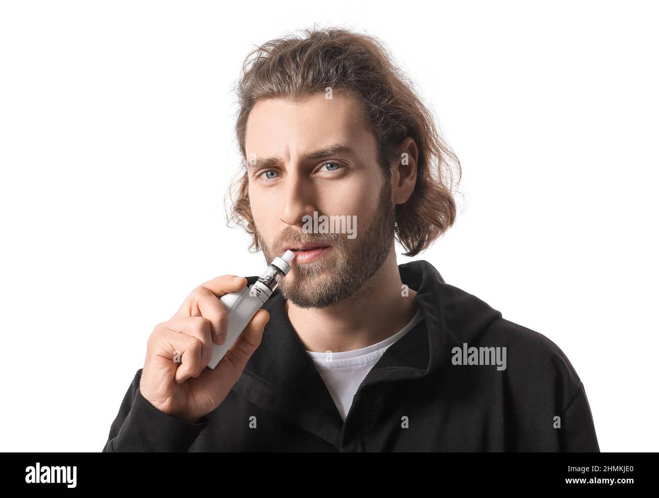 Vaping young man on white background Stock Photo - Alamy