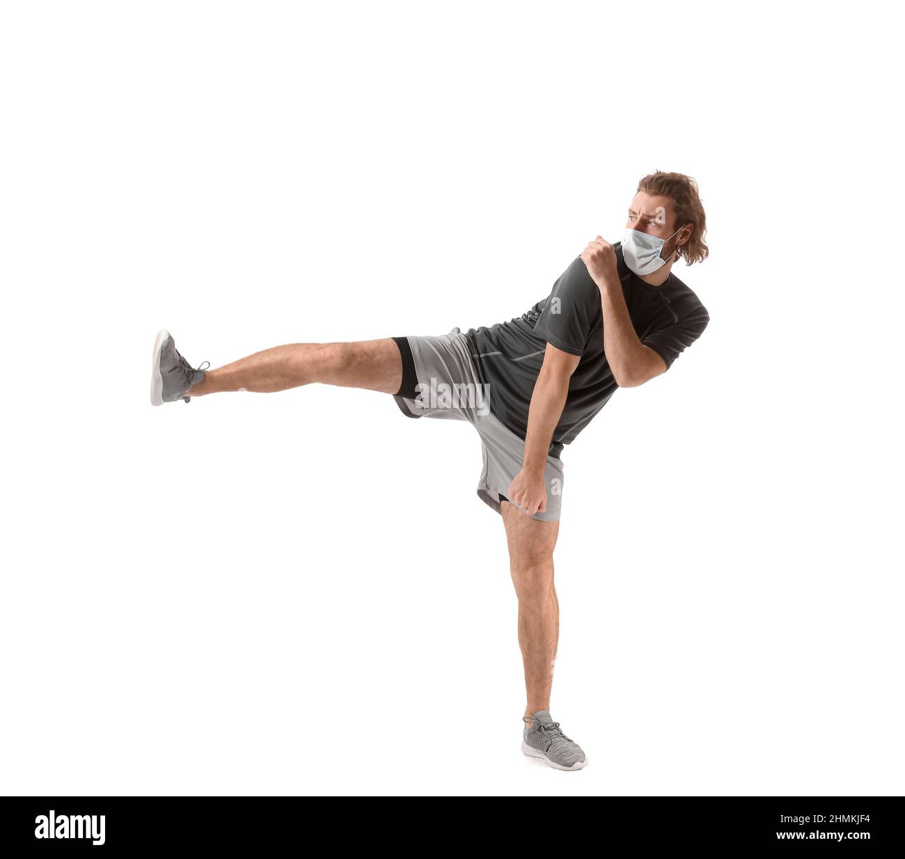 Male kickboxer in medical mask on white background Stock Photo - Alamy