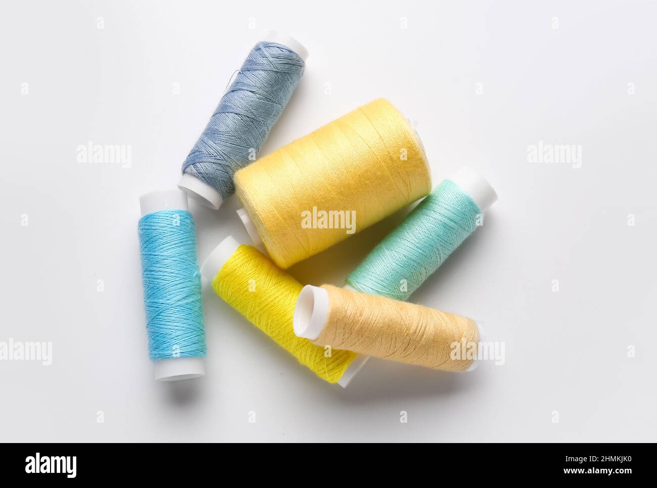 Different thread spools on white background Stock Photo - Alamy