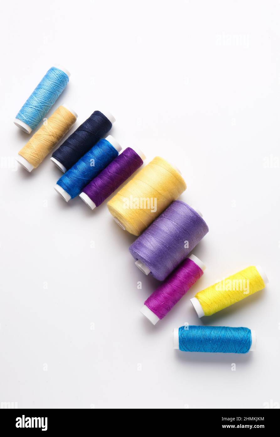 Different thread spools on white background Stock Photo - Alamy