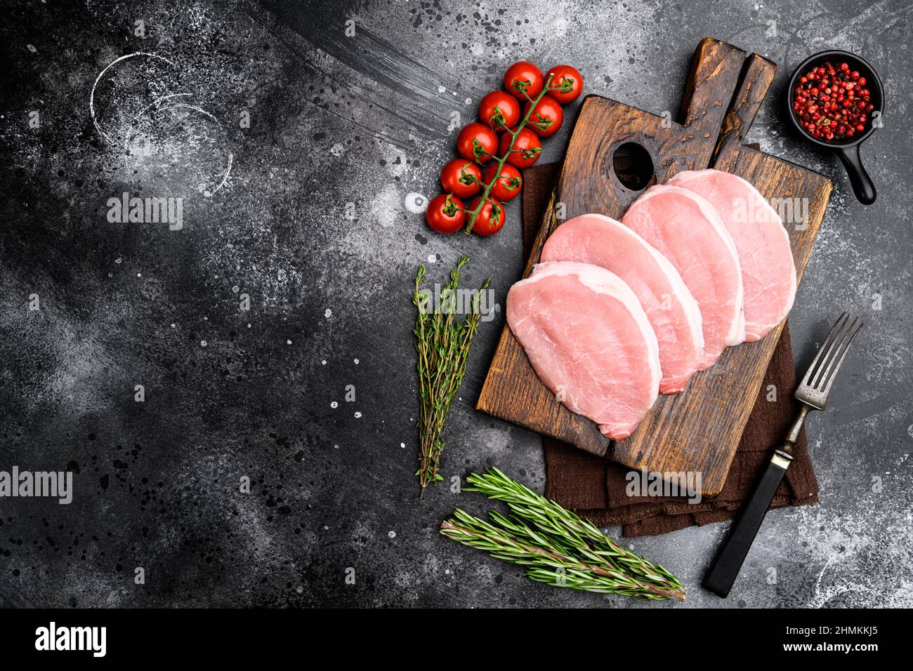 Raw pork steak meat set, on black dark stone table background, top view ...