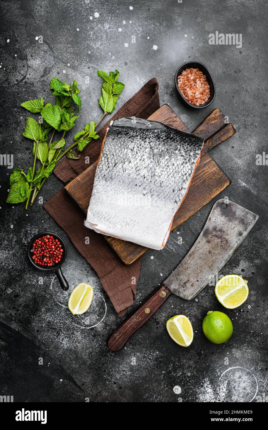 Raw whole salmon cut set, on black dark stone table background, top ...