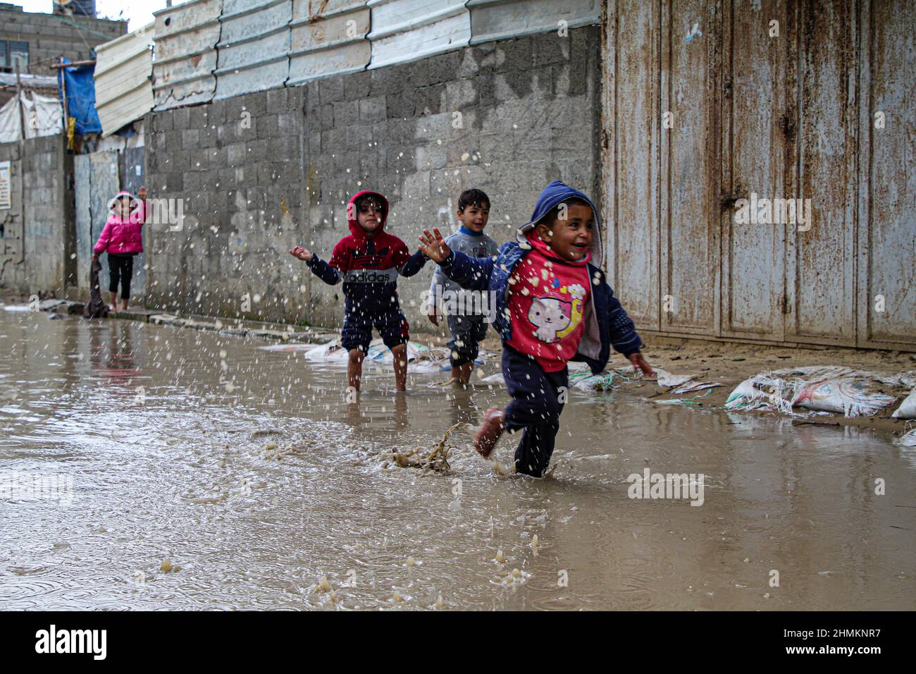 Gaza. 10th Feb, 2022. Palestinian children play on a waterlogged street ...