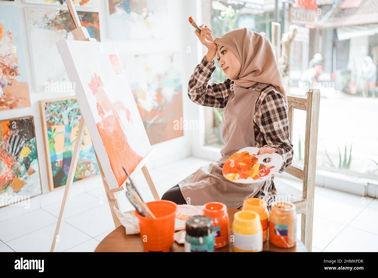 muslim female artist while working in her project at studio Stock Photo ...