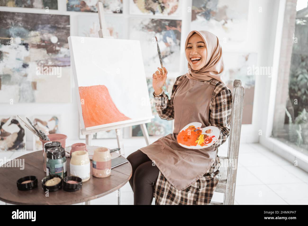 muslim female painter painting on canvas in her workshop Stock Photo ...