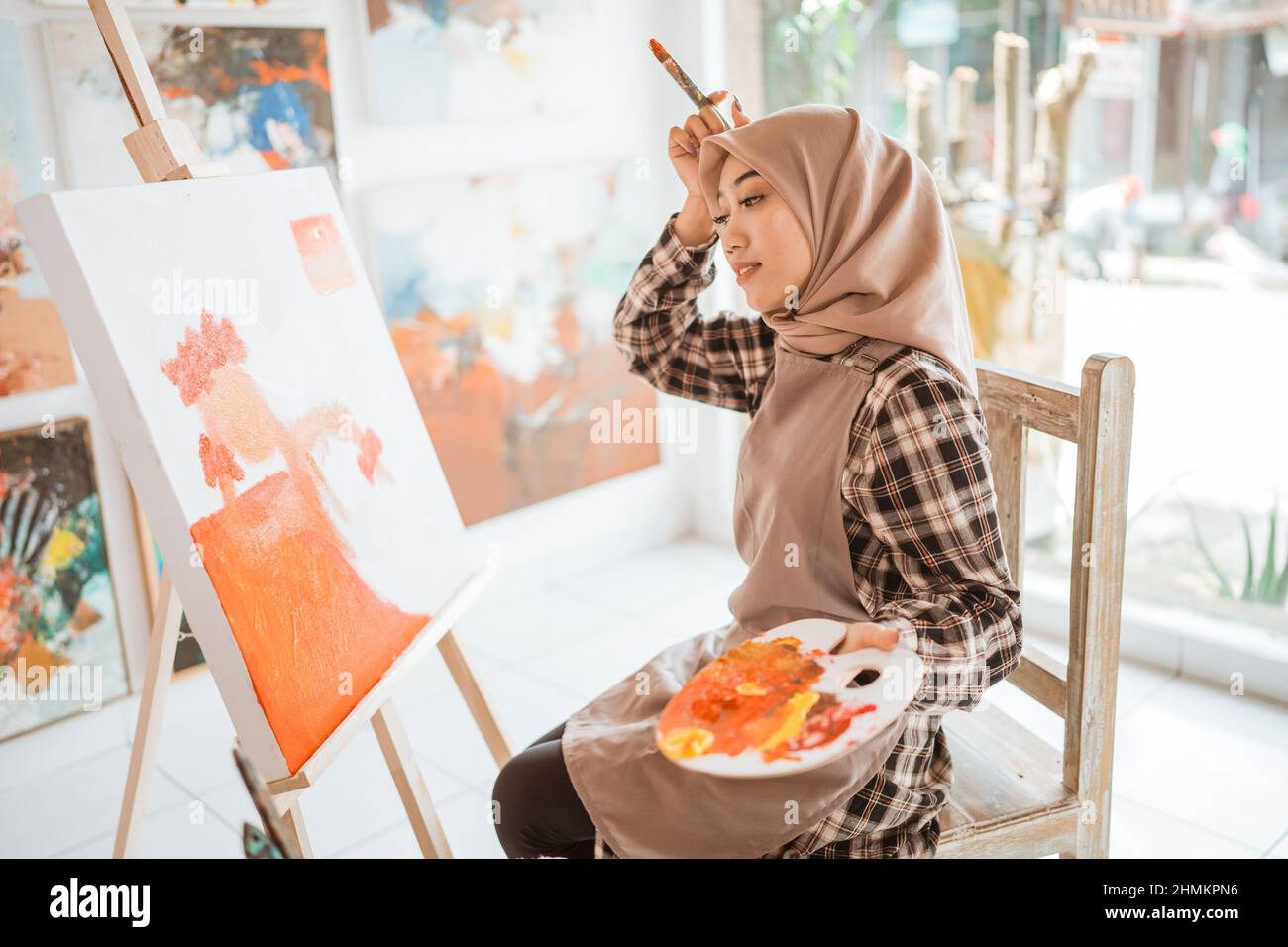 muslim female artist while working in her project at studio Stock Photo ...
