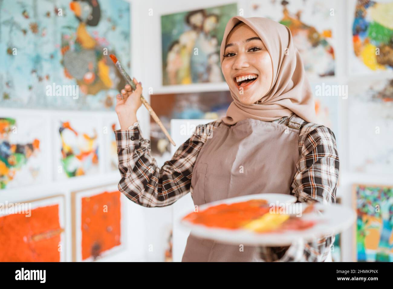 muslim painter is painting in her workshop excitedly Stock Photo - Alamy