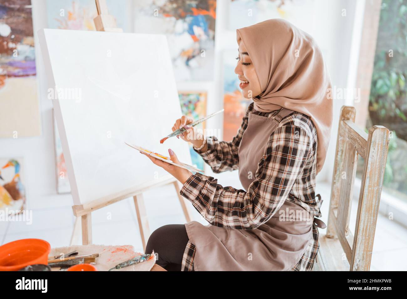 muslim asian female artist painting on canvas Stock Photo - Alamy