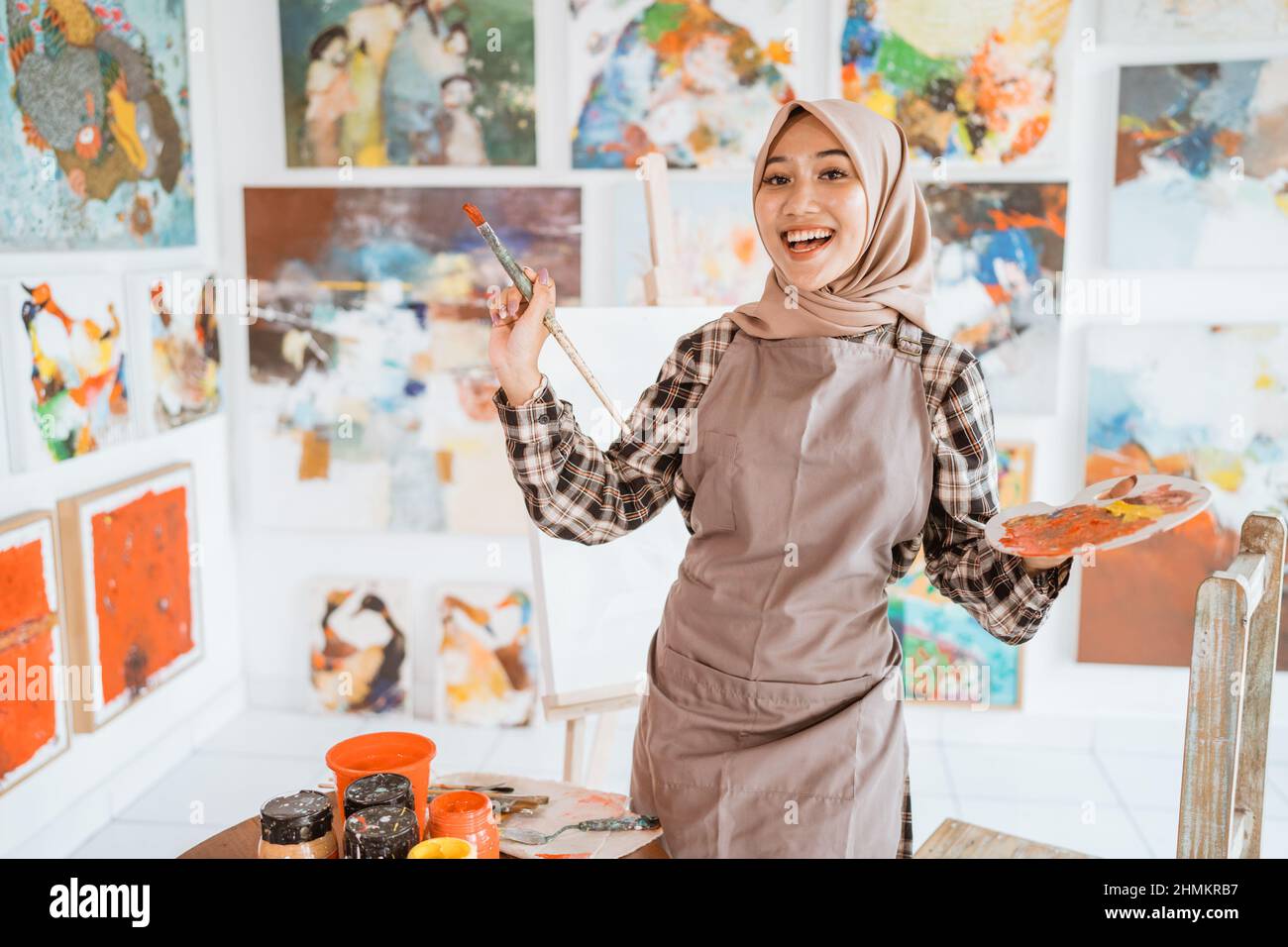 muslim female painter painting on canvas in her workshop Stock Photo ...