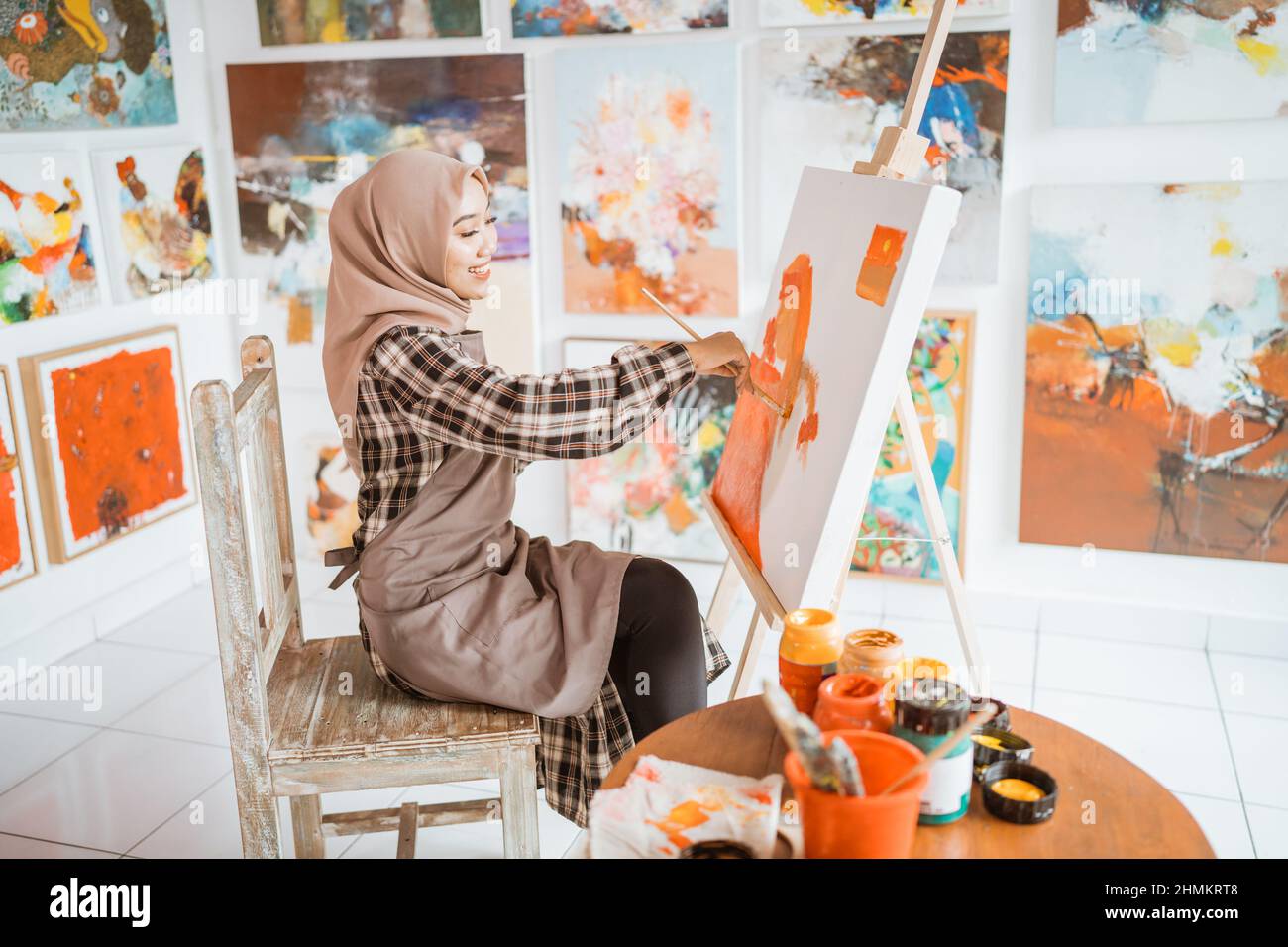 muslim asian female artist painting on canvas Stock Photo - Alamy