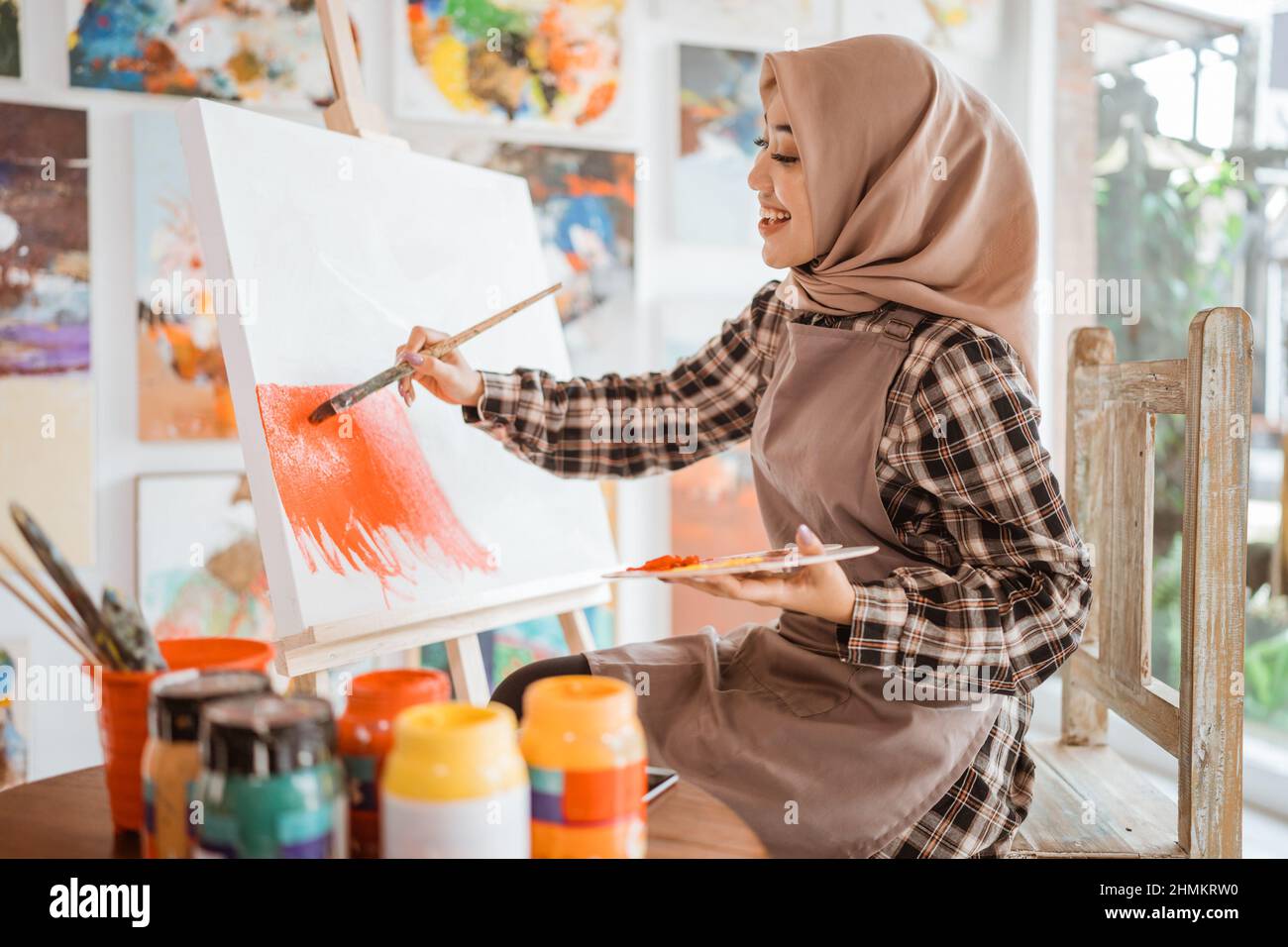 muslim asian female artist painting on canvas Stock Photo - Alamy
