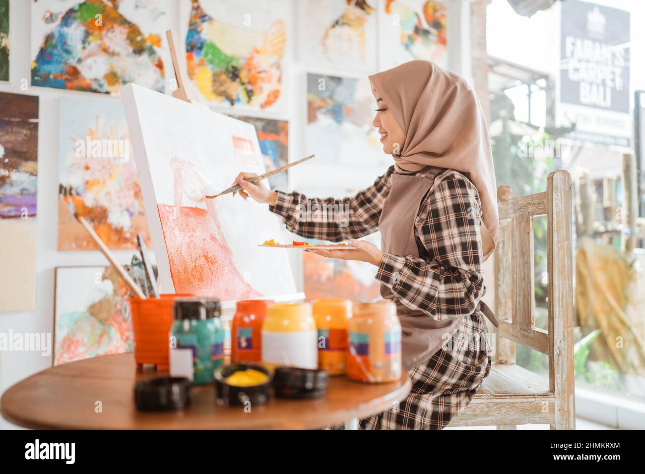 muslim asian female artist painting on canvas Stock Photo - Alamy