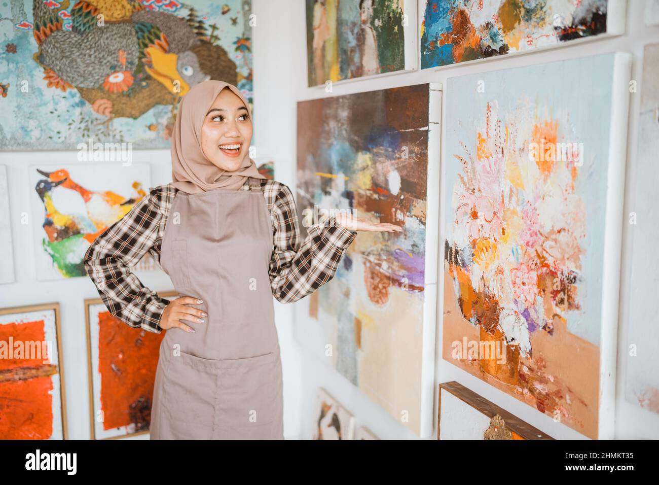muslim female painter standing next to her work proudly and smile Stock ...