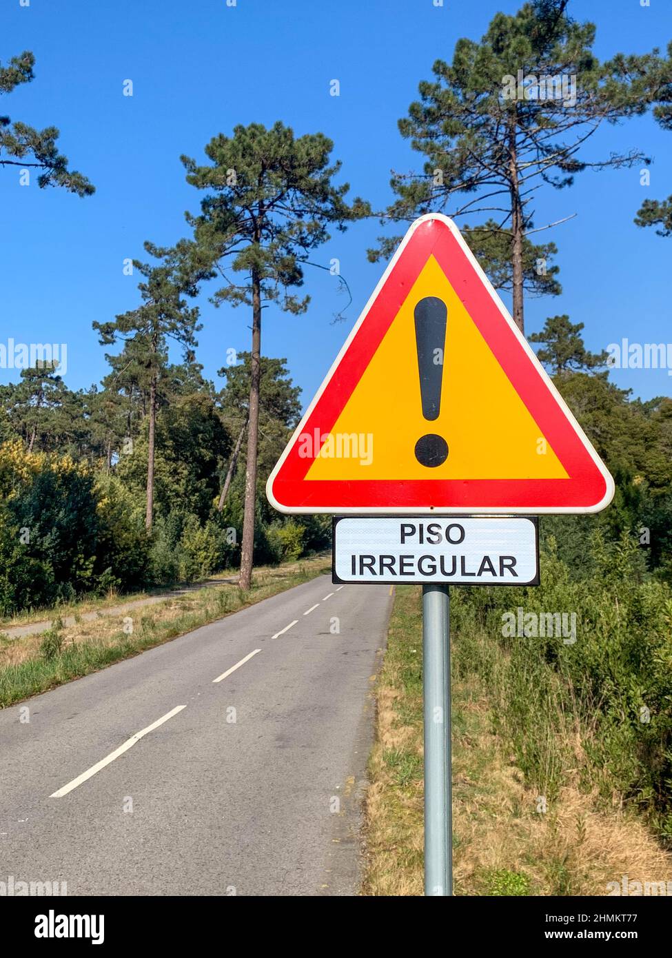 Bumpy road warning sign with an exclamation mark in red triangle on ...