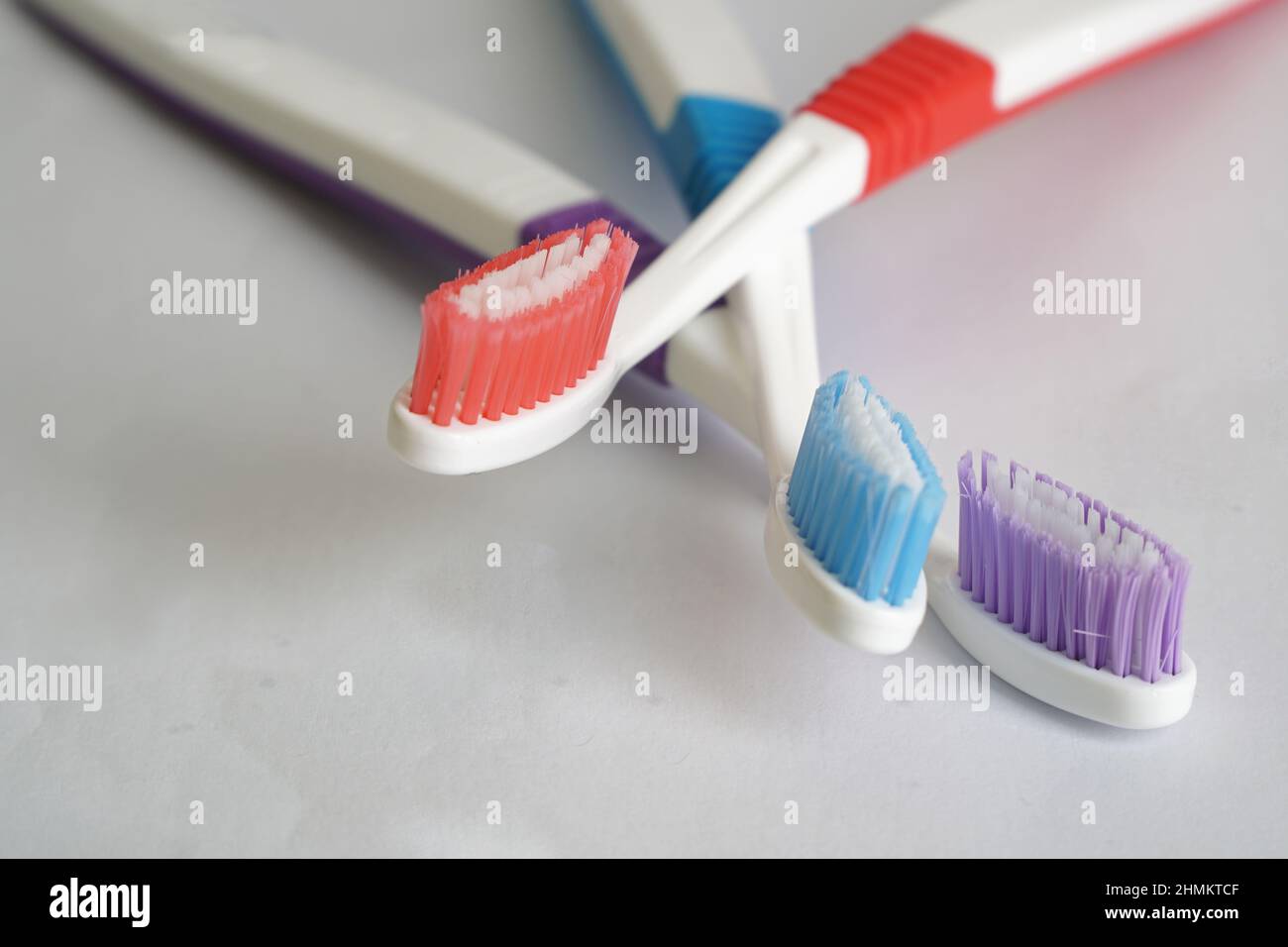 three color of toothbrush, red, blue, and purple Stock Photo - Alamy
