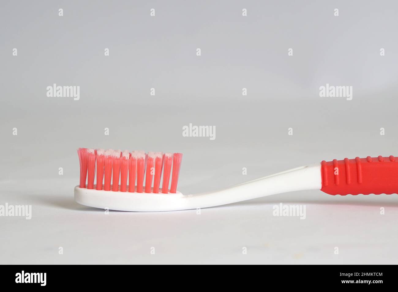 toothbrush in color red, isolated white background Stock Photo - Alamy