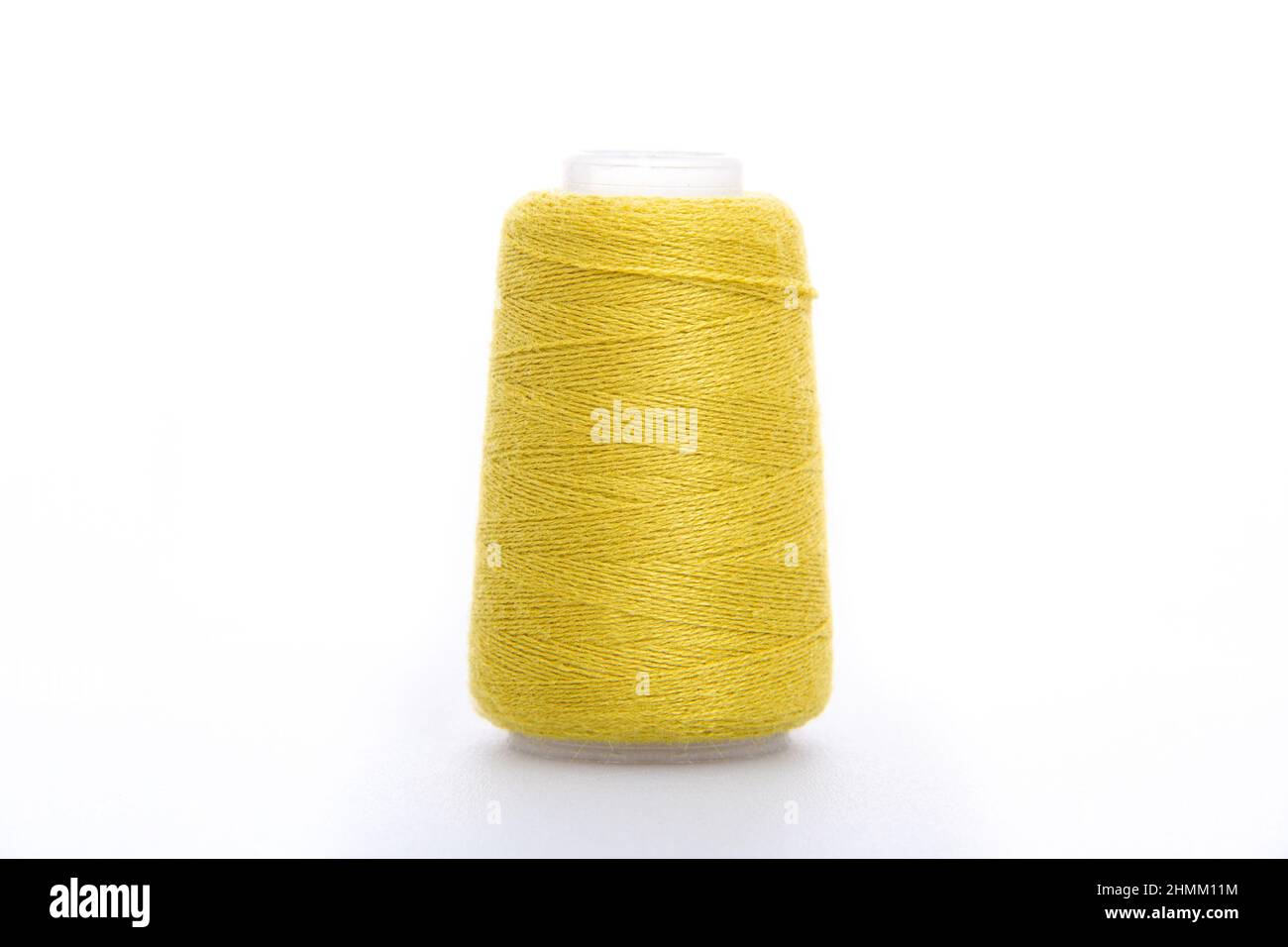 Yellow spool of thread isolated on white background. Skein of woolen ...