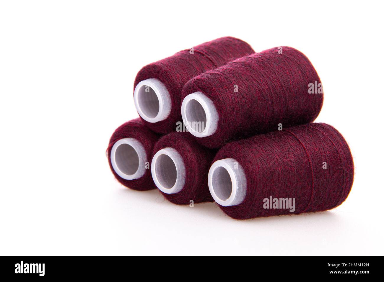 Red spool of thread isolated on white background. Skein of woolen ...