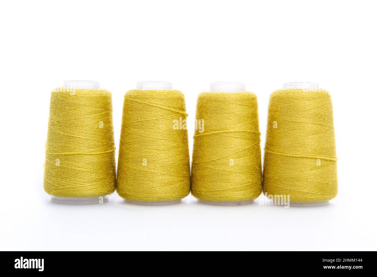 Yellow spool of thread isolated on white background. Skein of woolen ...