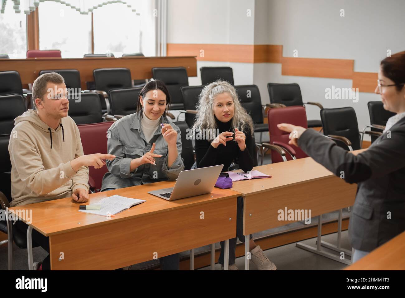 The teacher and students communicate in sign language in the classroom ...