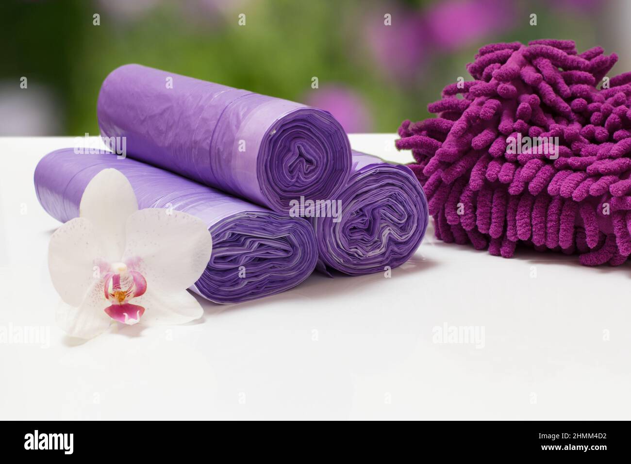 Garbage bags, a rag and a white orchid flower with natural background ...