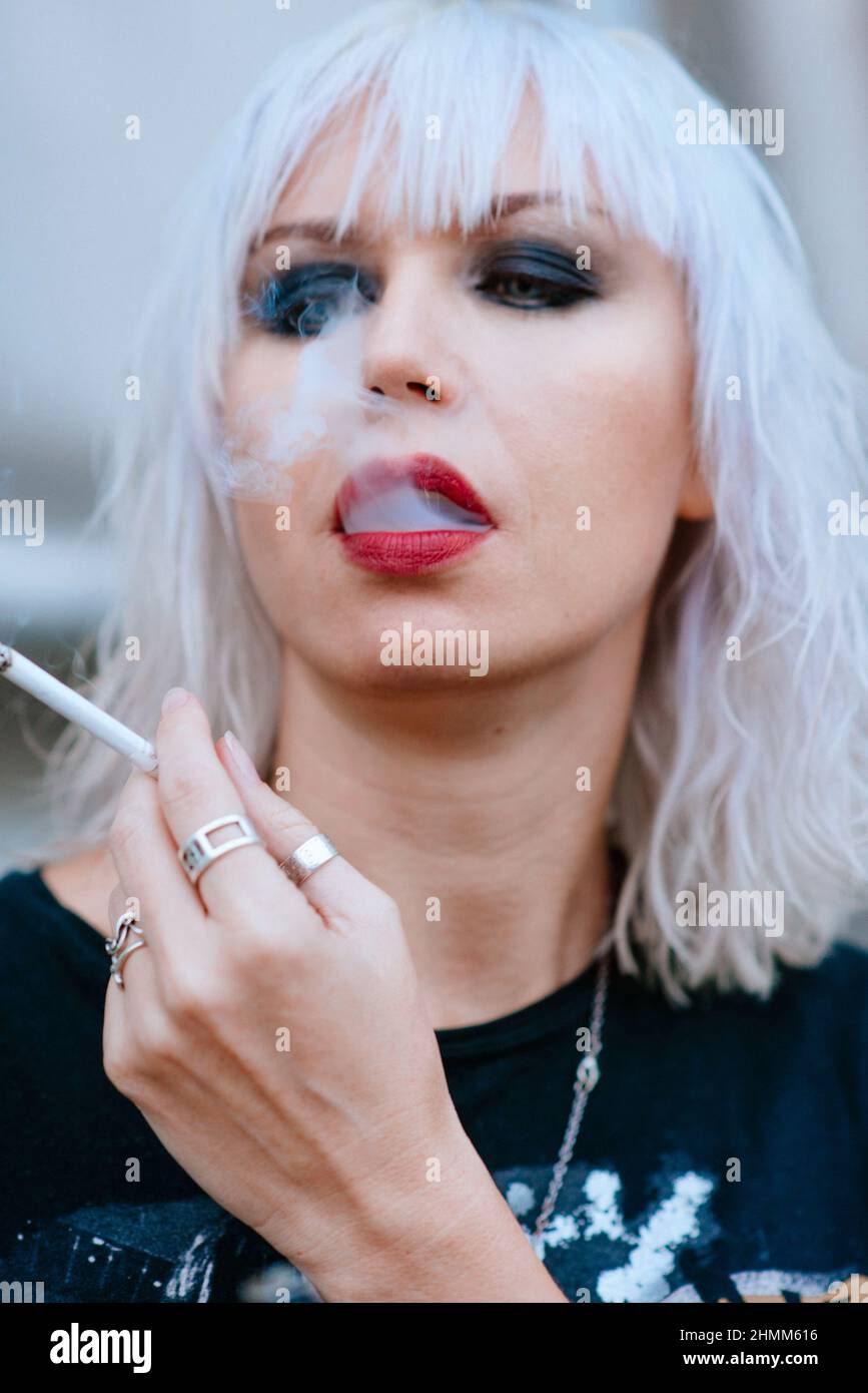 Stylish young woman smoking hi-res stock photography and images - Alamy