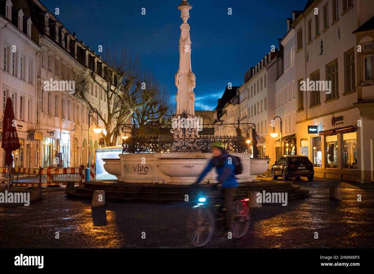 11 February 2022, Saarland, Saarbrücken: A cyclist rides past the ...