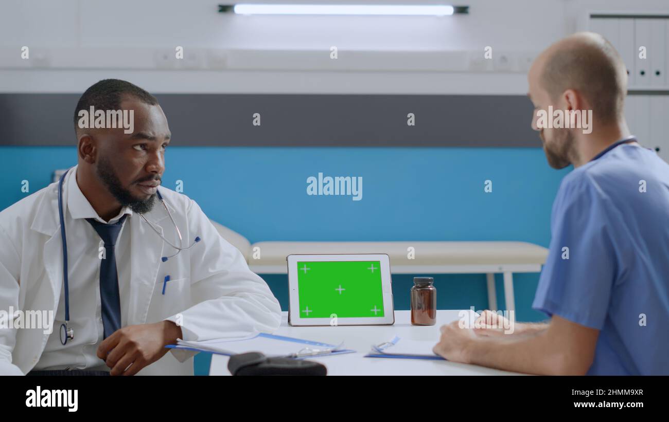 African american physician doctor explaining sickness symptoms to man ...