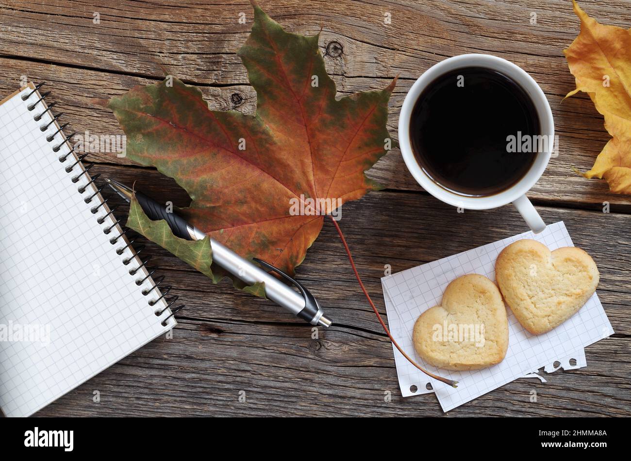 Top view of a notebook, coffee, cookies in the shape of a heart, autumn ...