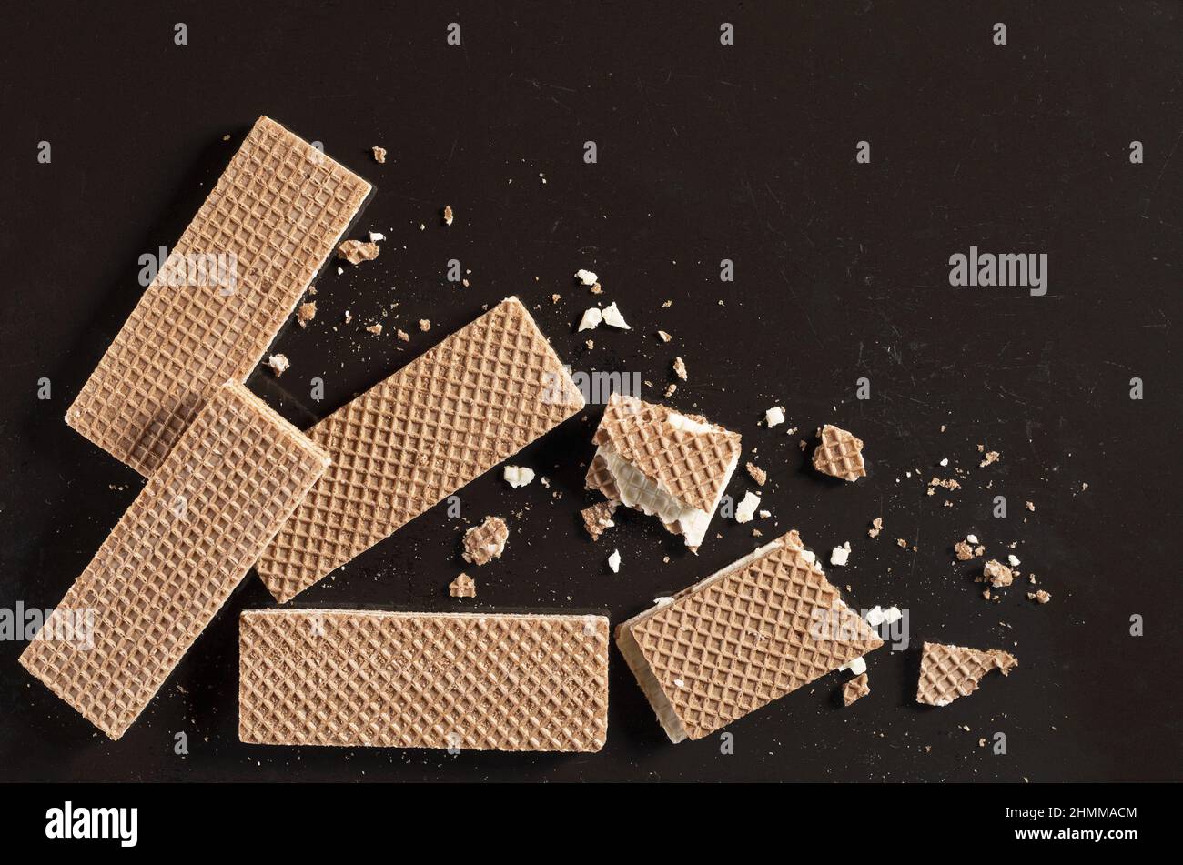 Chocolate wafers whole and broken on old black metal background, top ...