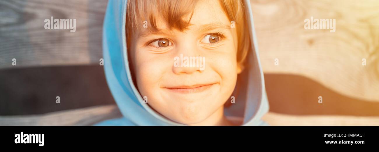 portrait of face happy smiling candid five year old kid boy in blue ...