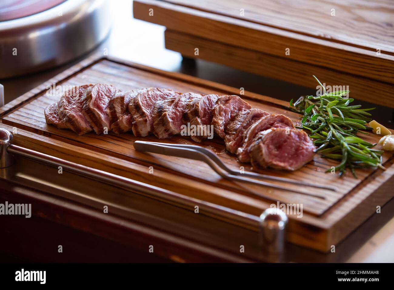 the chef prepares a steak in the restaurant hall Stock Photo - Alamy