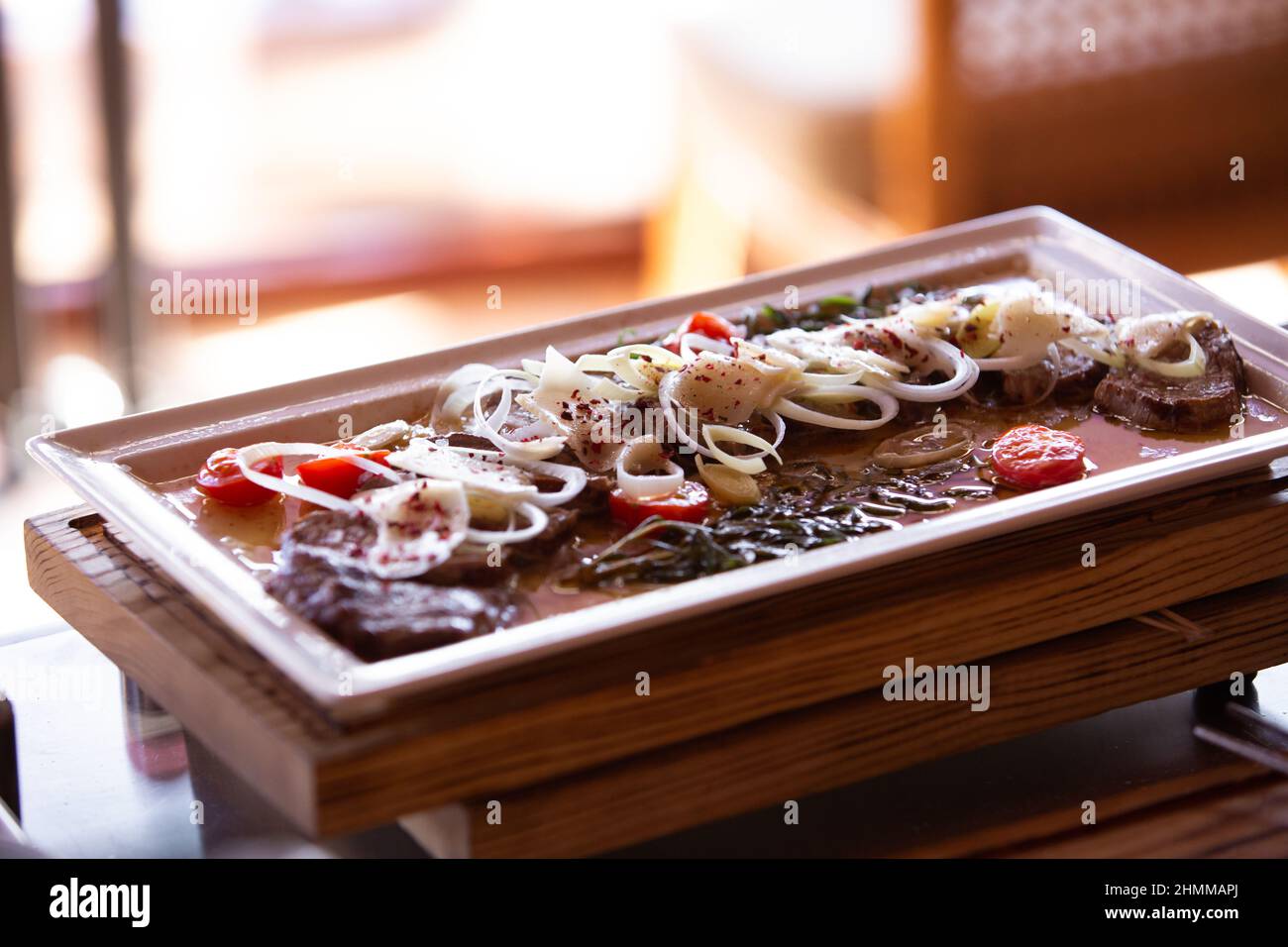 the chef prepares a steak in the restaurant hall Stock Photo - Alamy