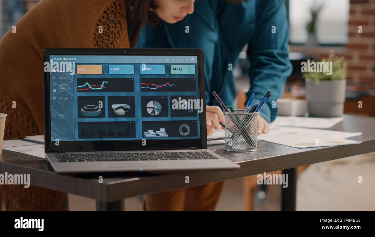 Close up of laptop screen with data rate charts on desk while ...