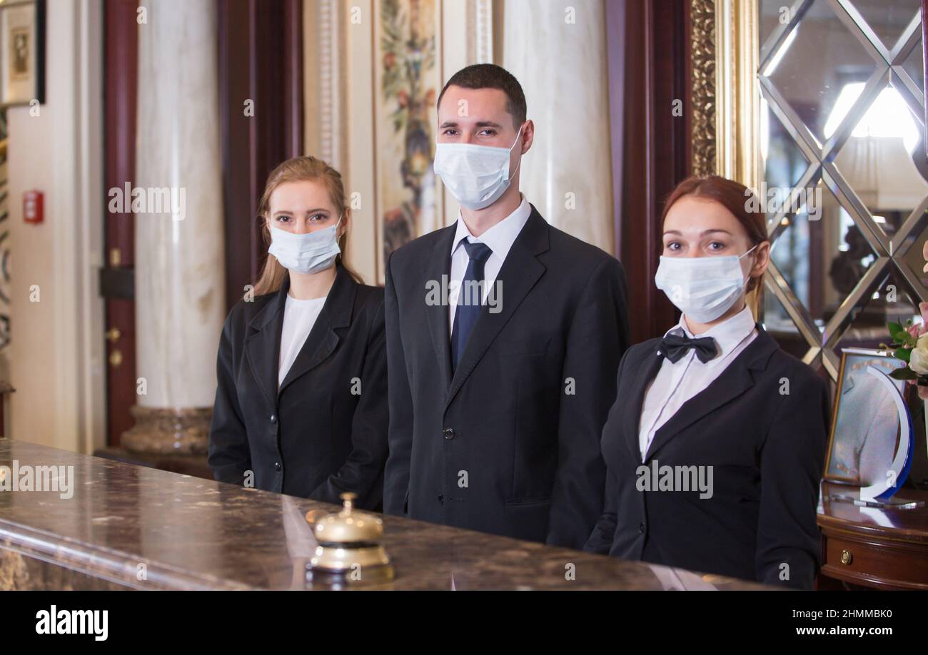 the hotel staff serves guests in medical masks Stock Photo - Alamy